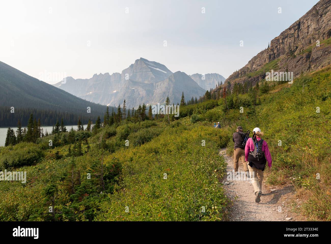 Visitors hike along the Grinnel Glacier Trail amid wildfire smoke in ...