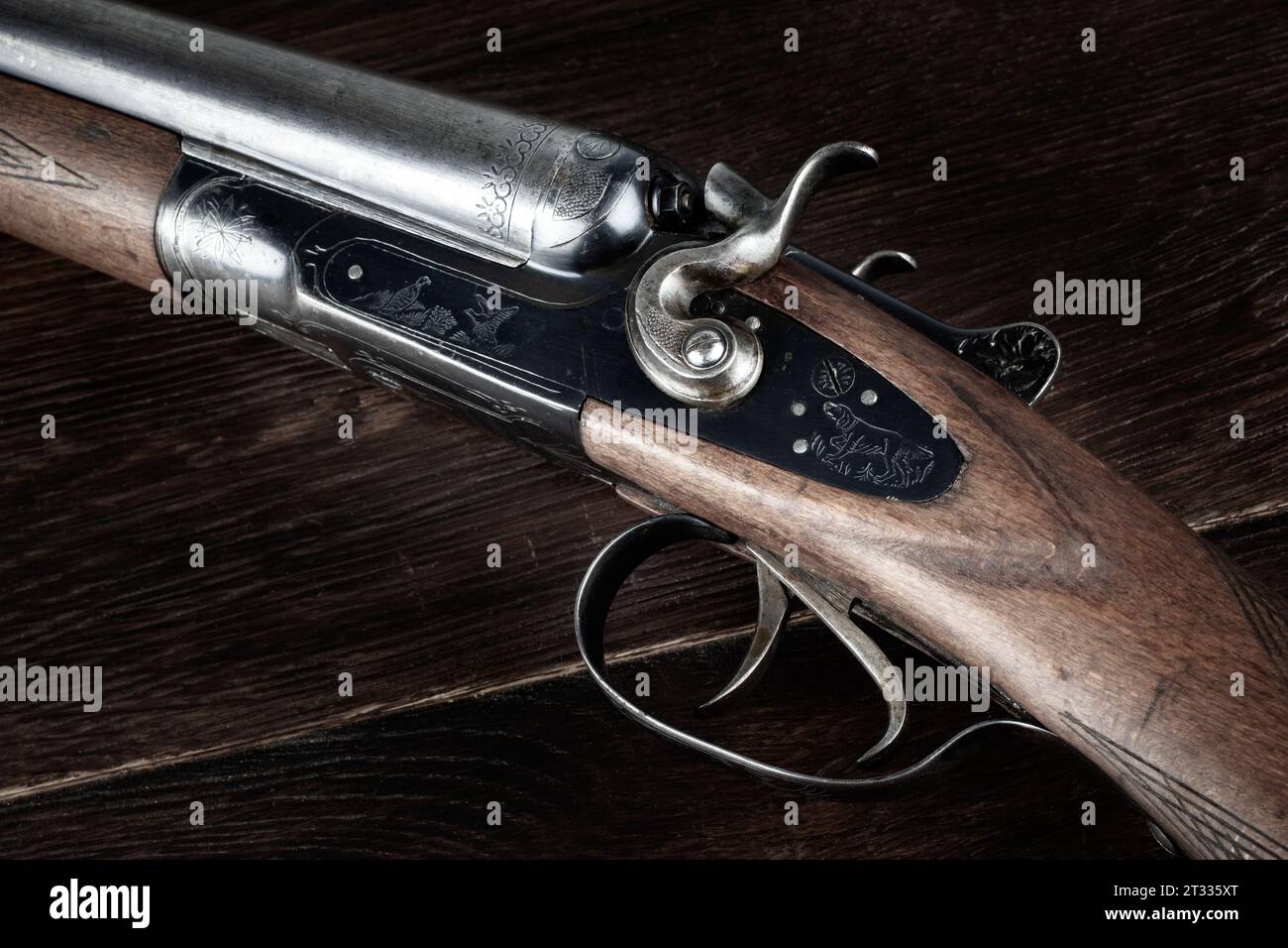 Antique 12-gauge break-action smooth-bored shotgun on wooden table ...