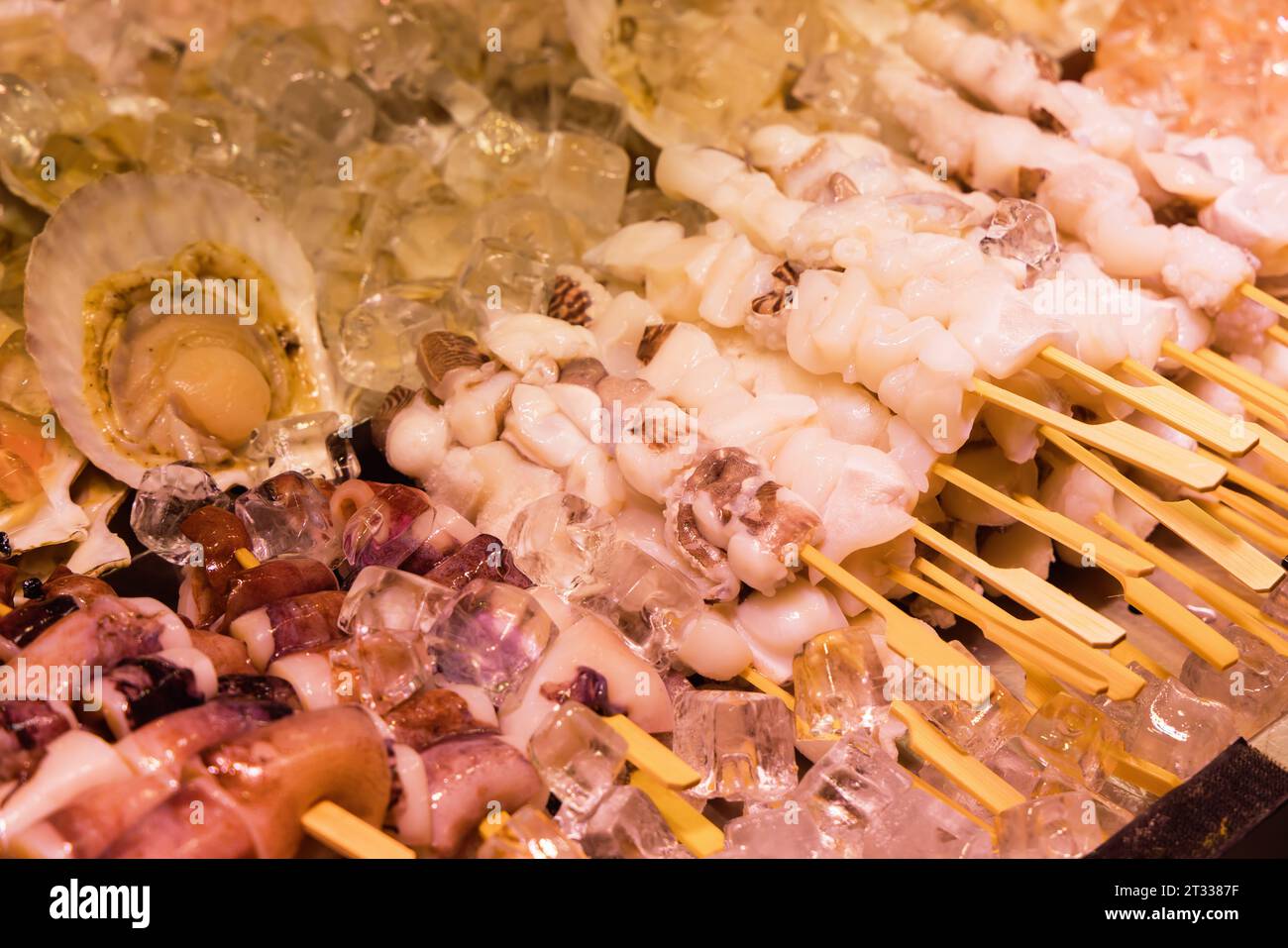 Display of skewers of raw squid at the famous Nishiki fish market in ...