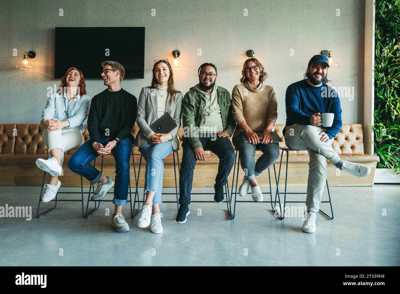 Group of business professionals sitting together in an office portrait ...