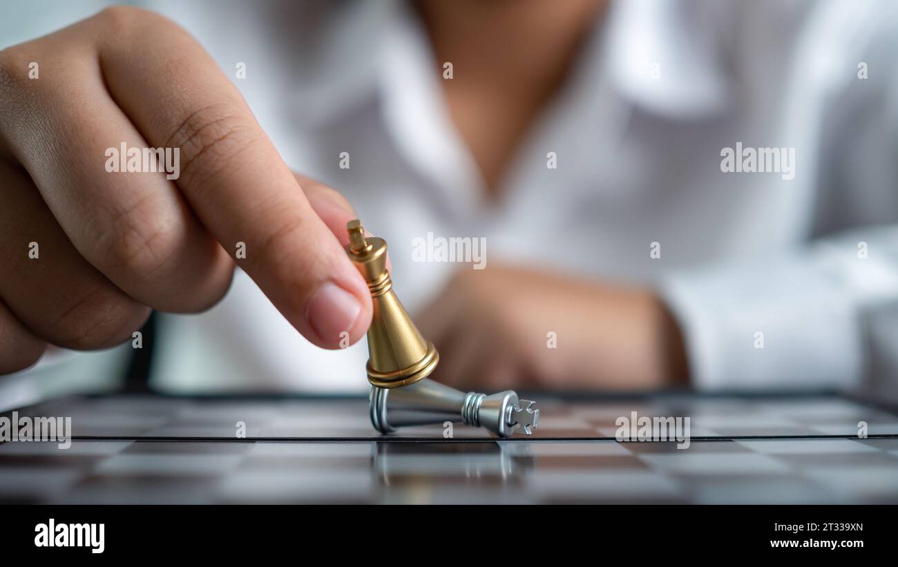 Businessman holding a king fighting on a chessboard represents concept ...