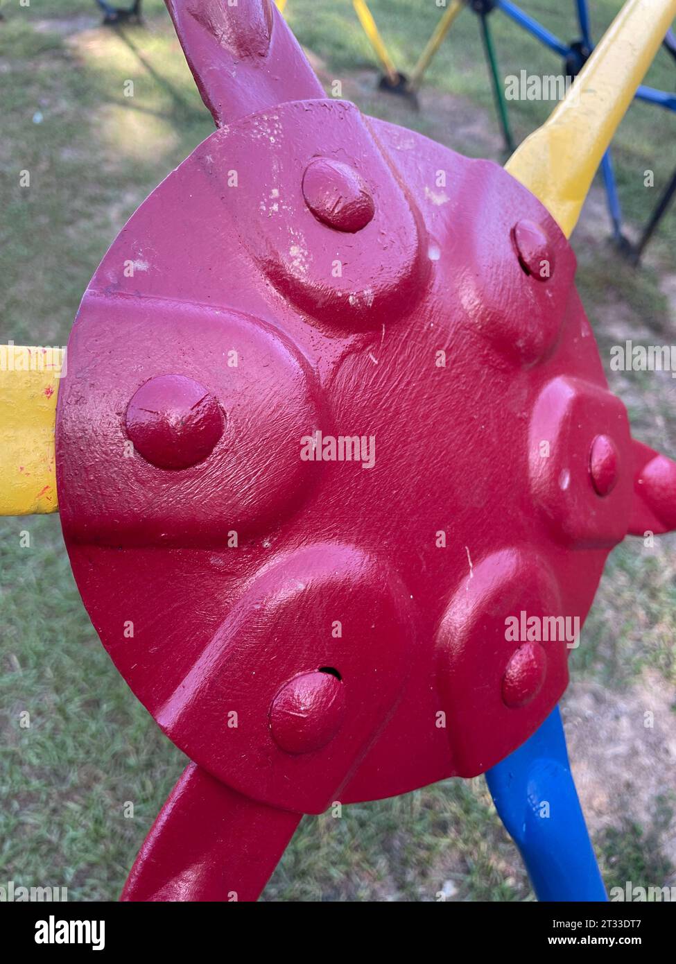 Red plate on monkey bars at the park close up background Stock Photo ...