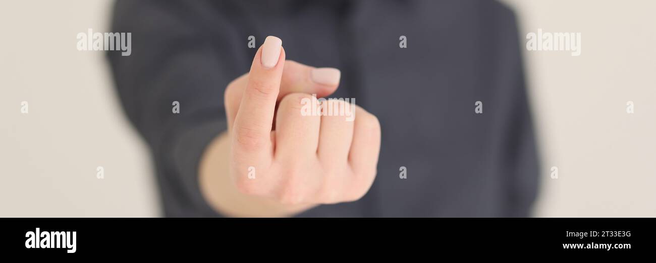 Woman shows beckoning sign in camera on beige background Stock Photo ...