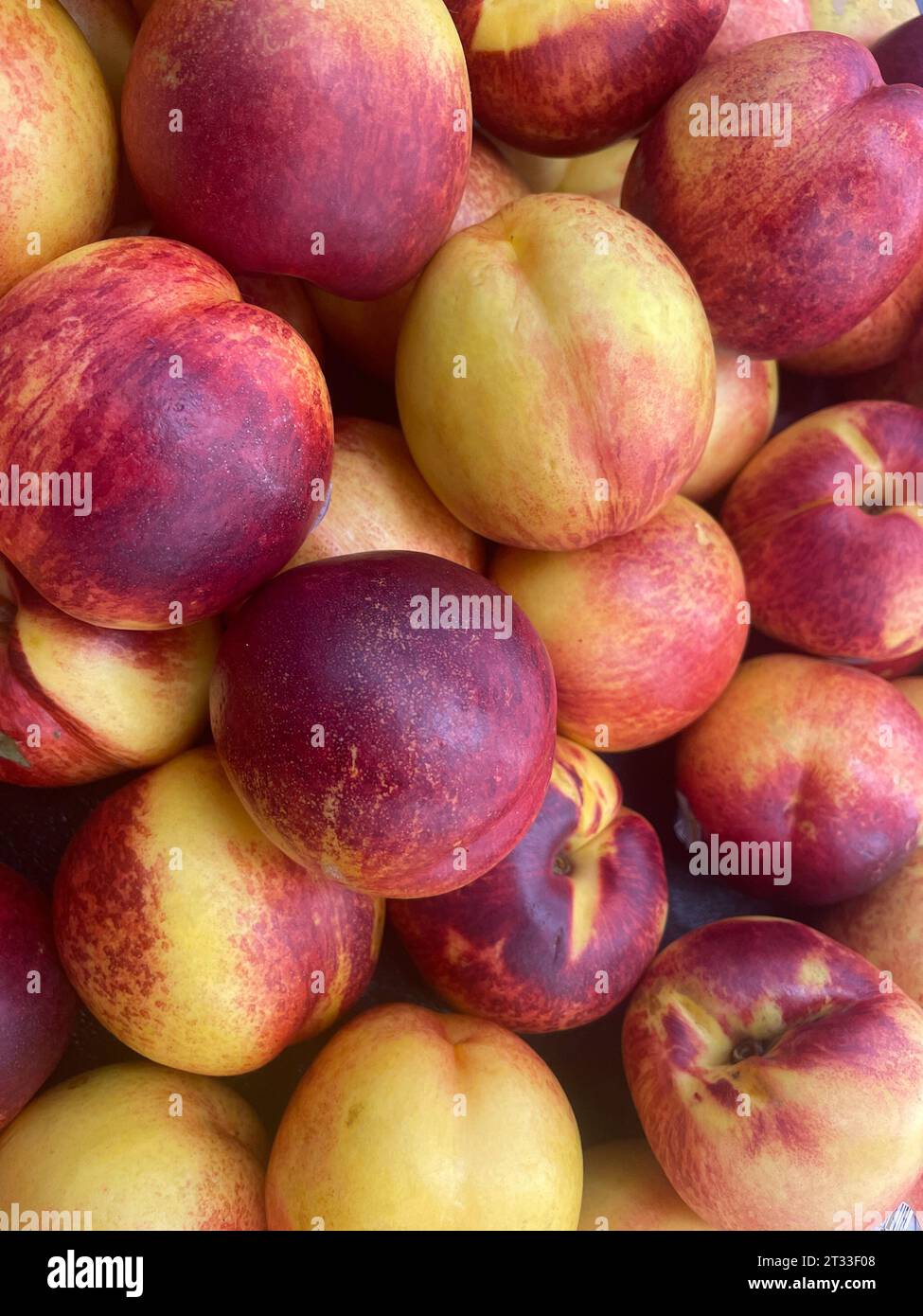Pile of Georgia Peaches on display in a grocery store food backgrounds ...