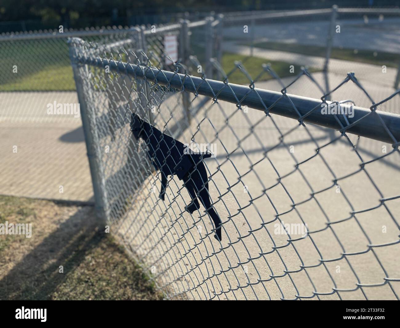 Dog emblem on a chain link fence at a dog park backgrounds Stock Photo ...