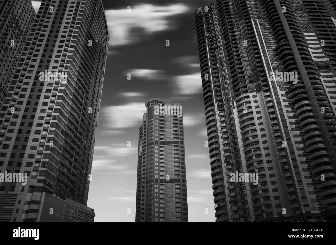 A cityscape with an array of multi-storied buildings silhouetted ...