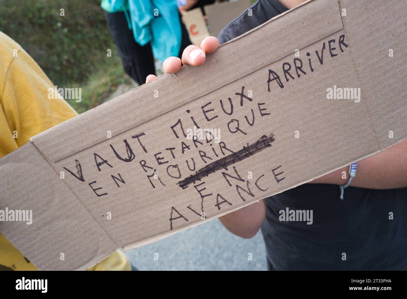 A placard, Better to arrive late than die early. Opening up procession ...