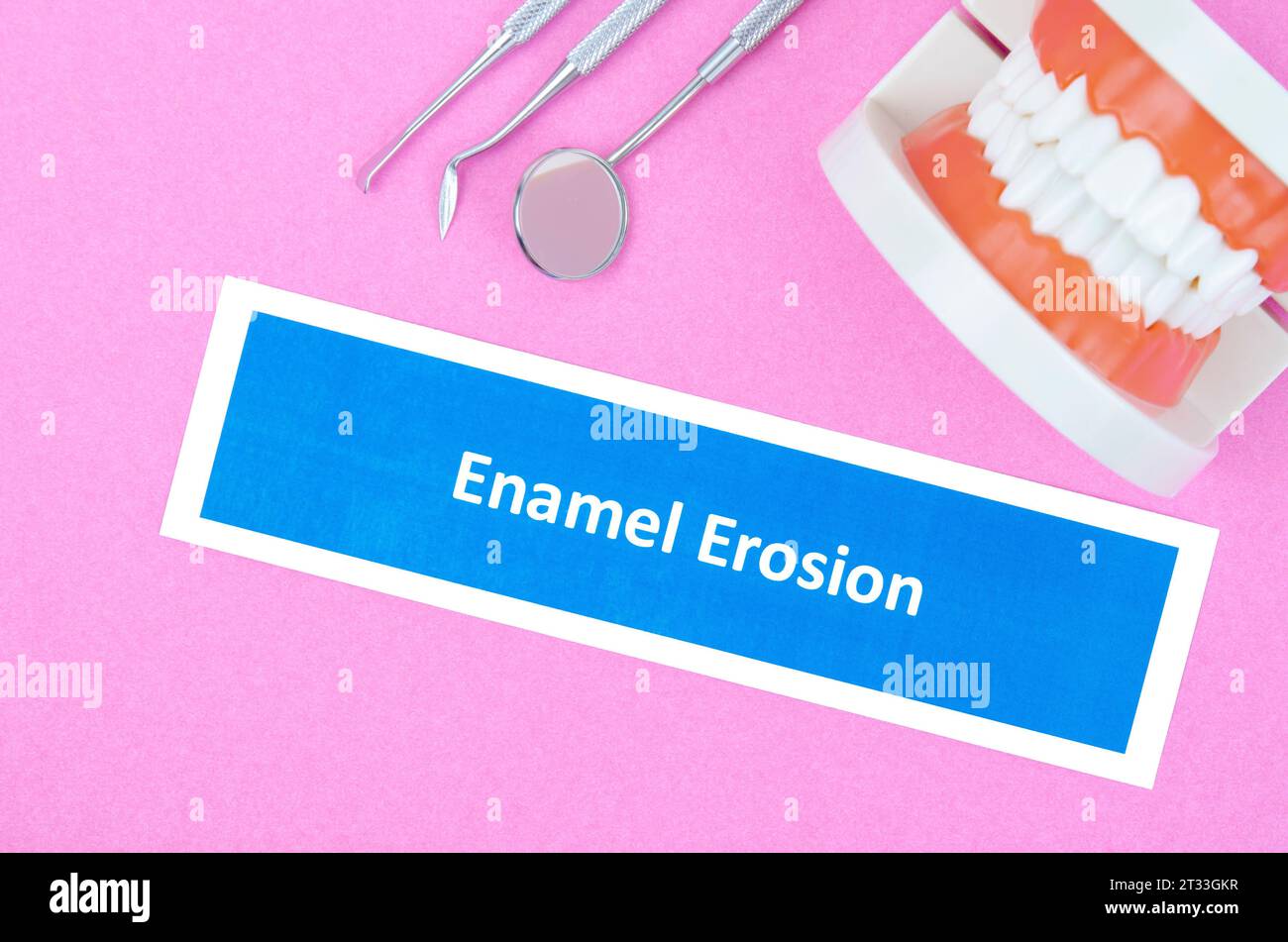 Enamel Erosion dental disease and teeth model with tools on pink color ...
