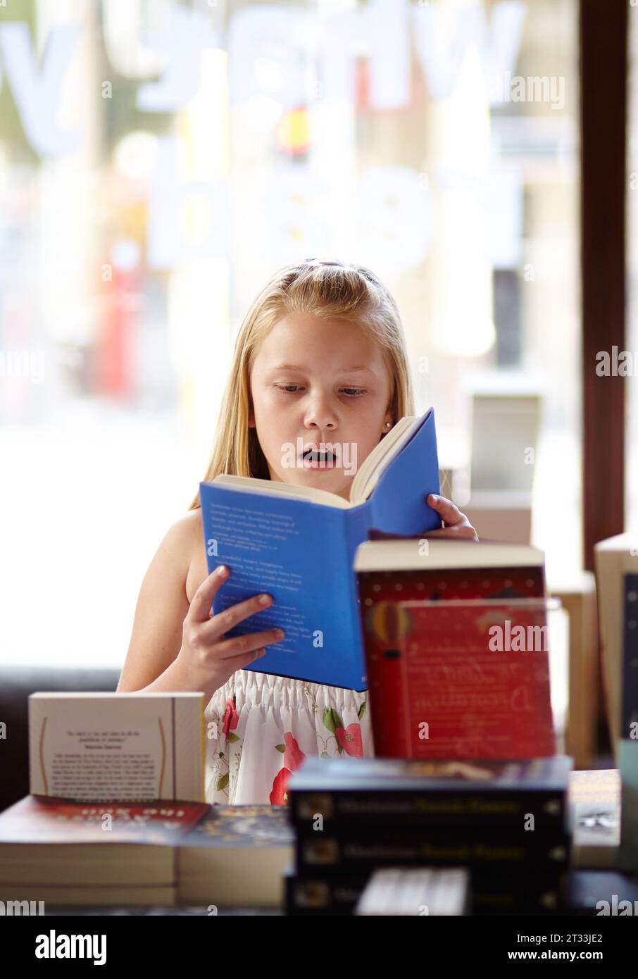Shock, stack of books and child in bookshop, learning and studying ...