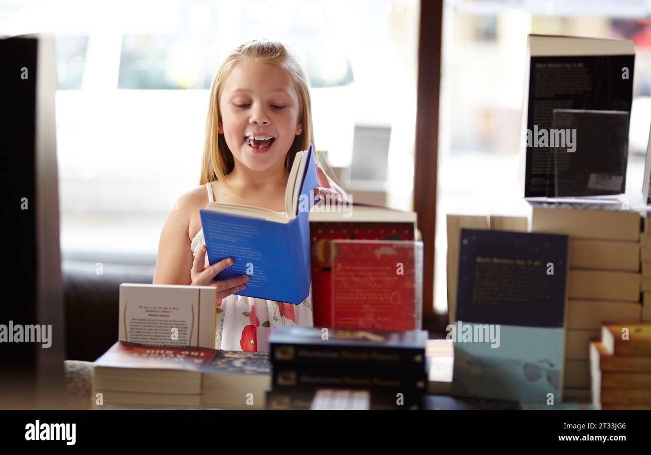 Smile, stack of books and child in bookshop, learning and relax ...