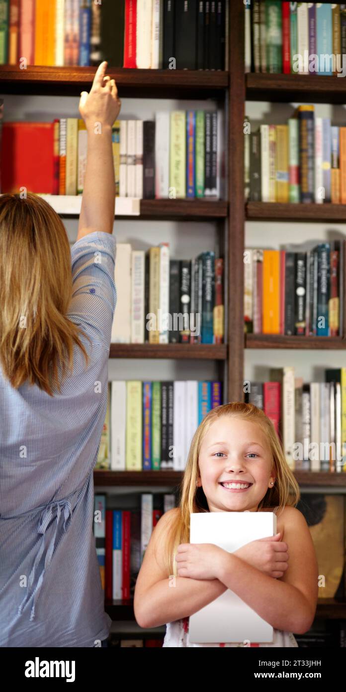 Portrait, books and child in library with excited smile, learning and ...