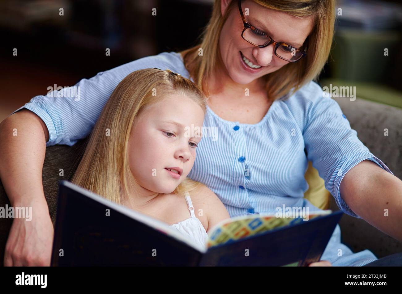 Reading, storytelling and mother with child in library with smile ...
