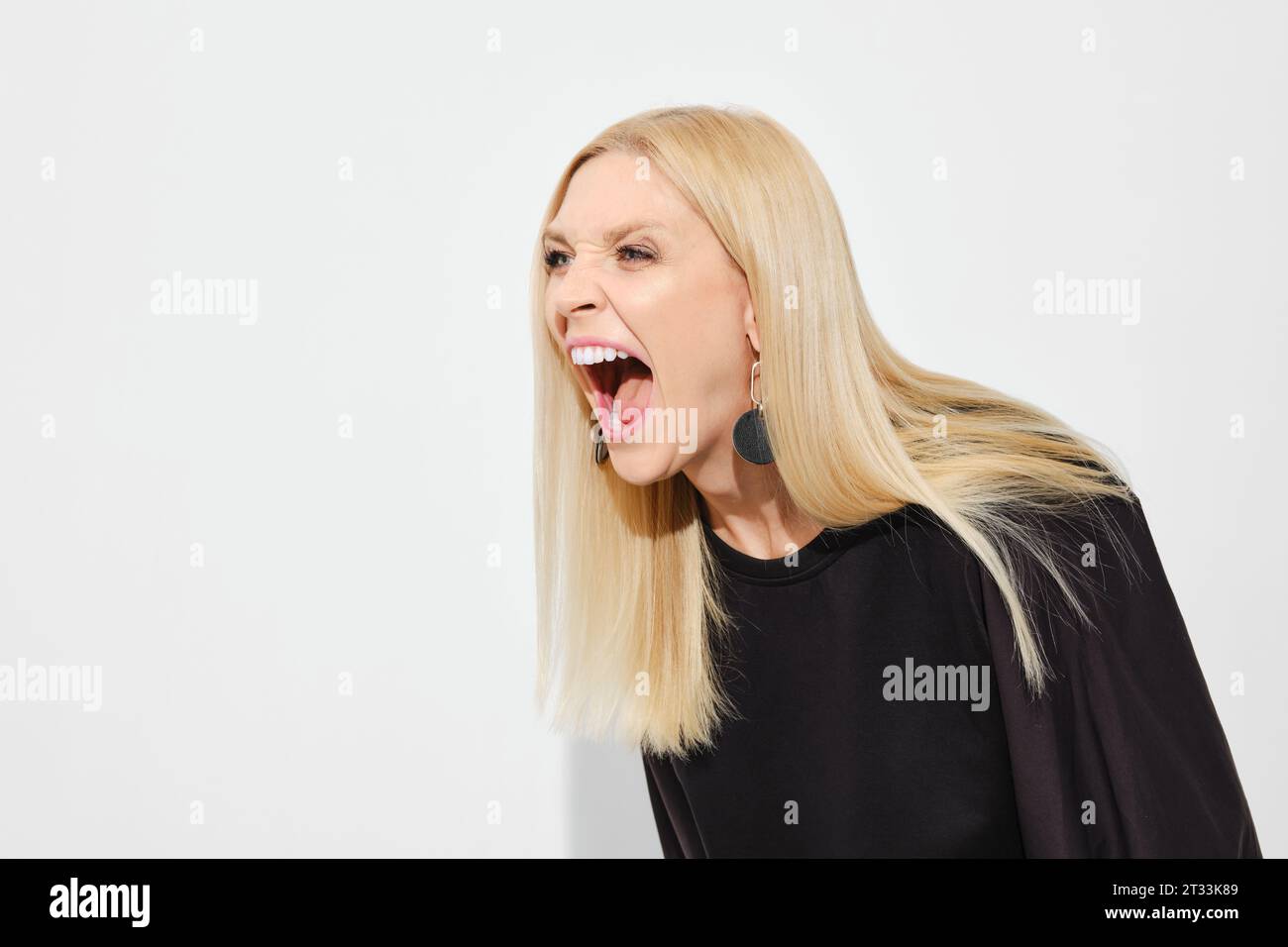 Woman leaning forward in studio hi-res stock photography and images - Alamy