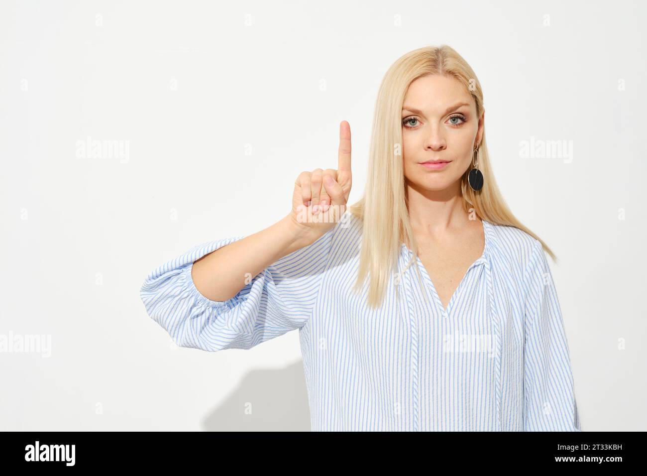 Attractive blonde woman shows one finger. Counting with fingers Stock ...