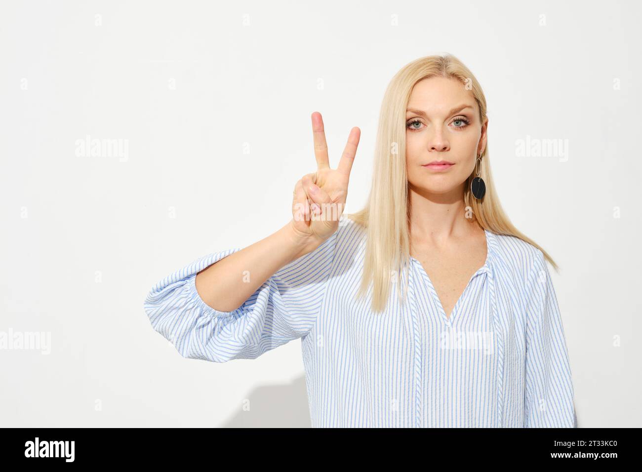 Attractive blonde woman shows two fingers. Counting with fingers Stock ...