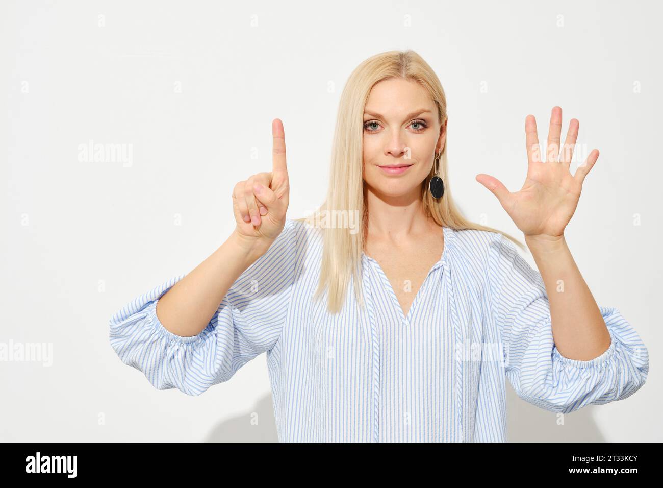 Attractive blonde woman shows six fingers. Counting with fingers Stock ...