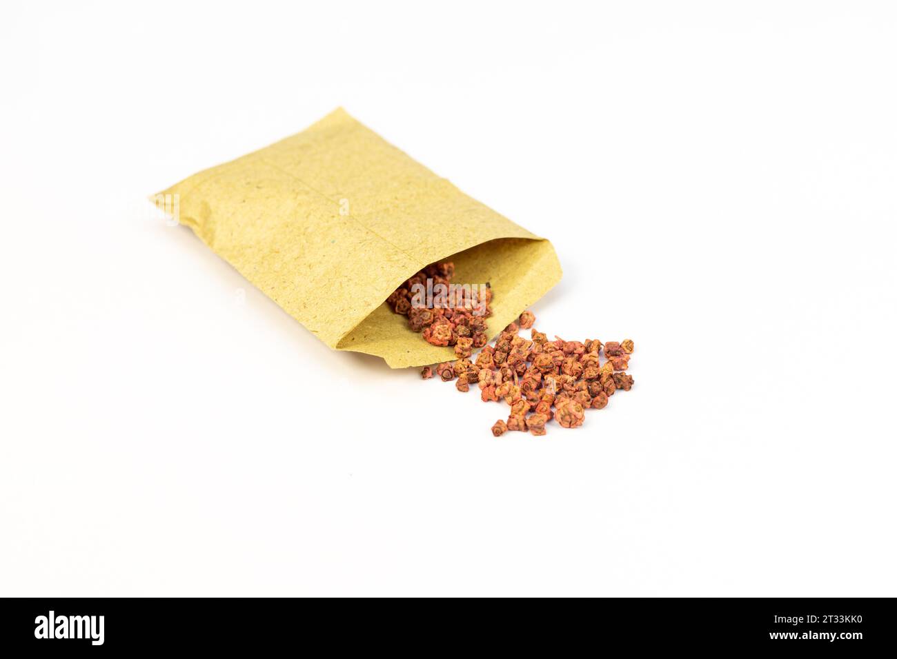 Beet root seeds pouring out from brown paper pack isolated on white ...