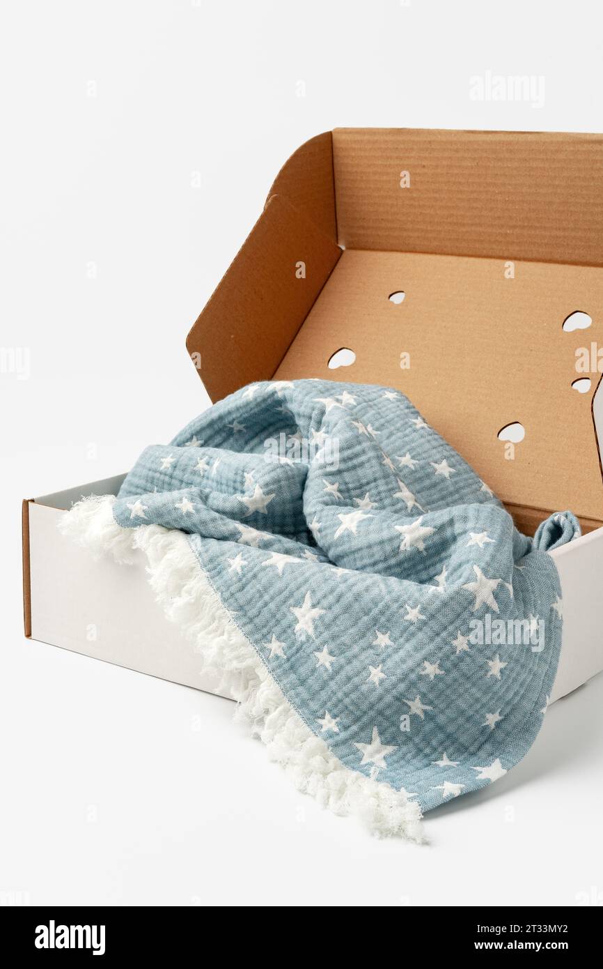 Blue cotton blanket in a box on white background Stock Photo - Alamy