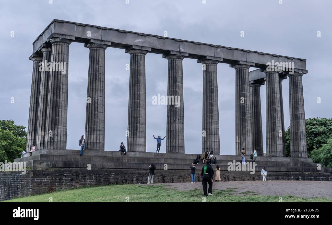 people admiring the National Monument of Scotland at Calton Hill ...
