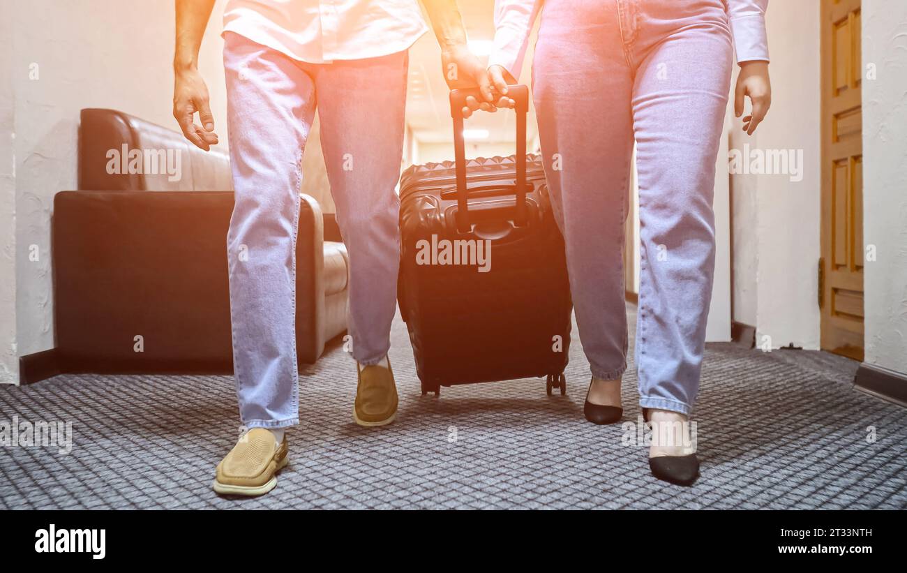 Tourist couple on vacation making way to booked hotel room Stock Photo ...