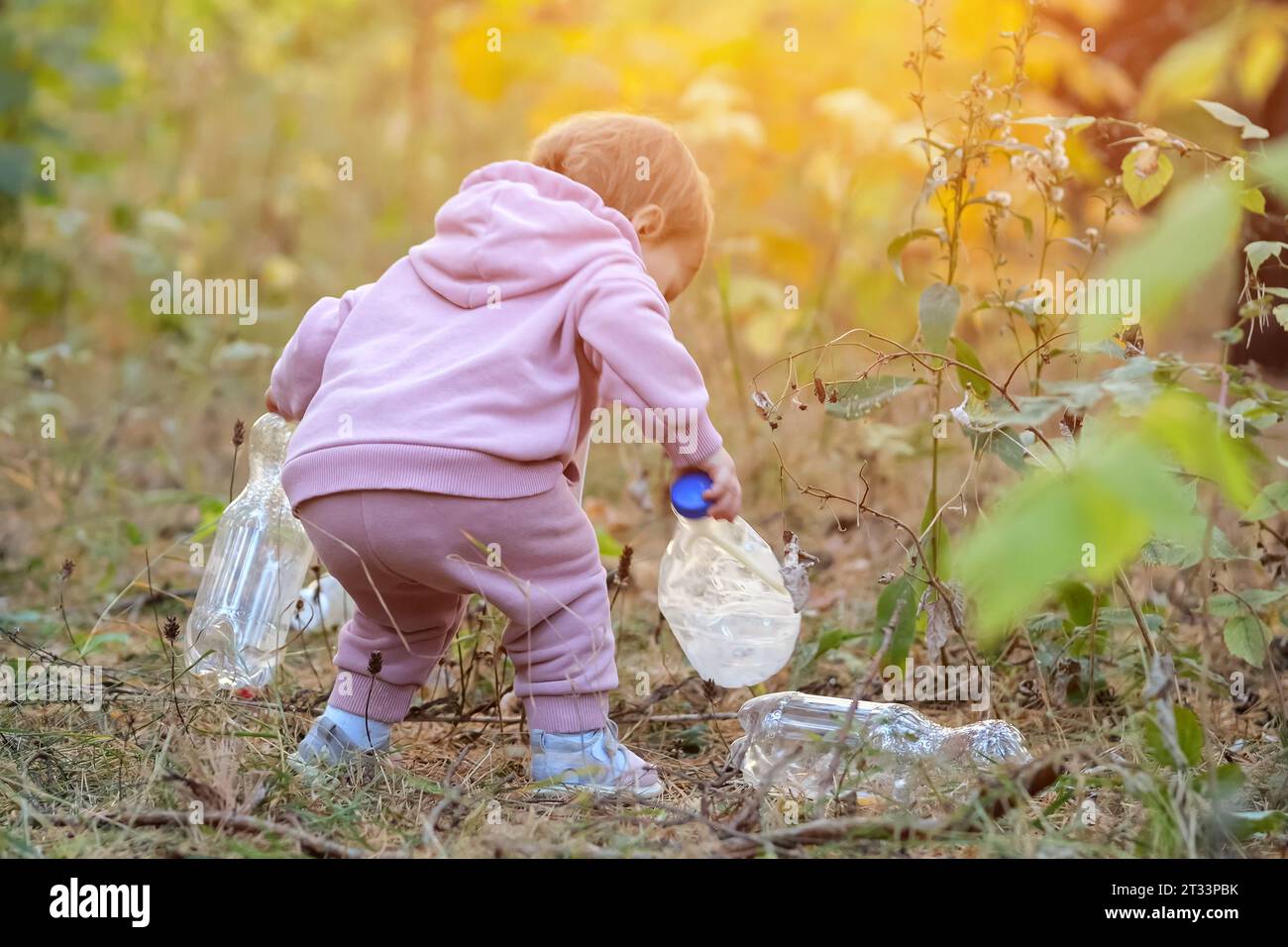 Toddler girl contributes to environmental conservation Stock Photo - Alamy
