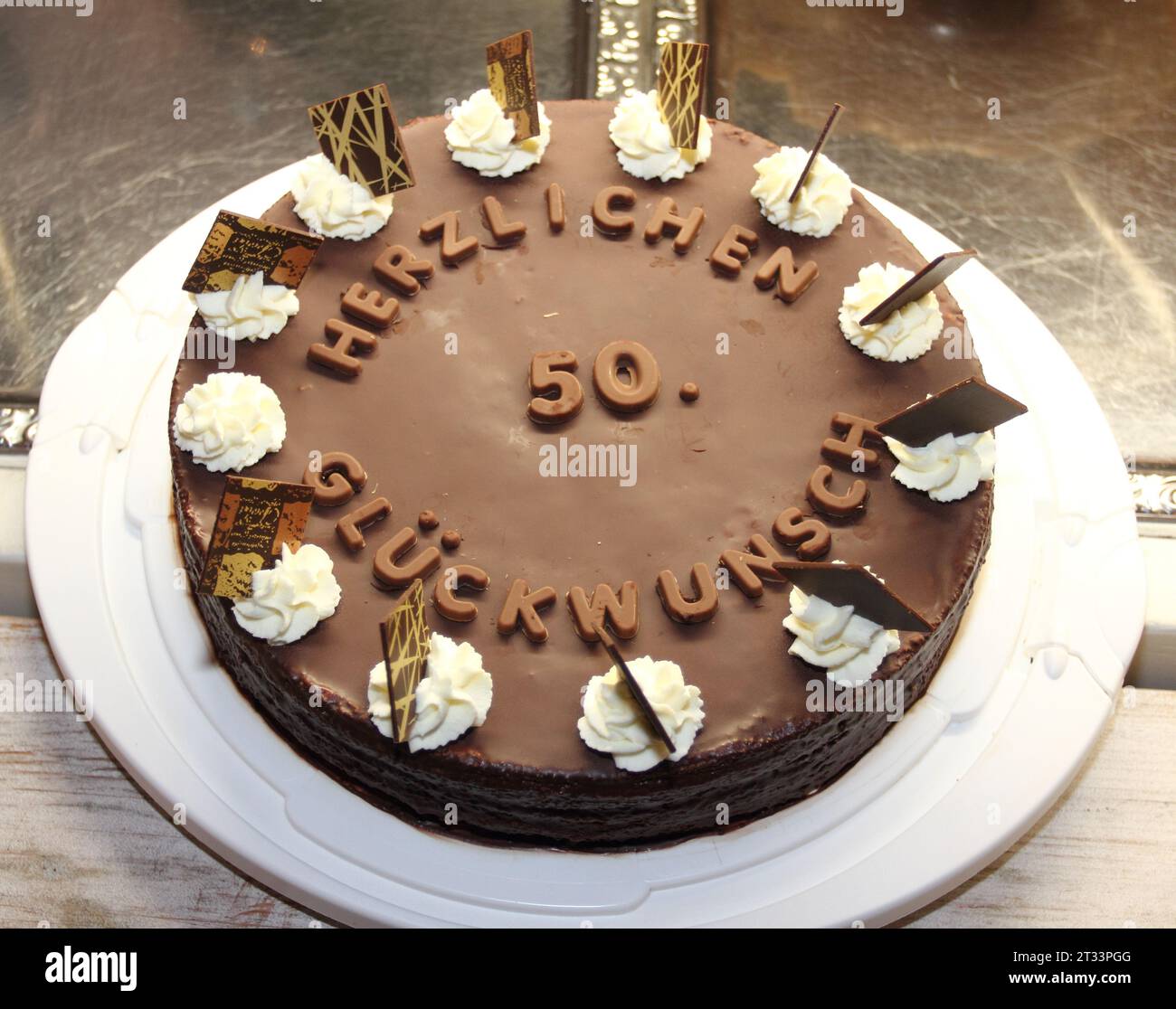 A round chocolate cake with embellishments and an inscription Stock ...