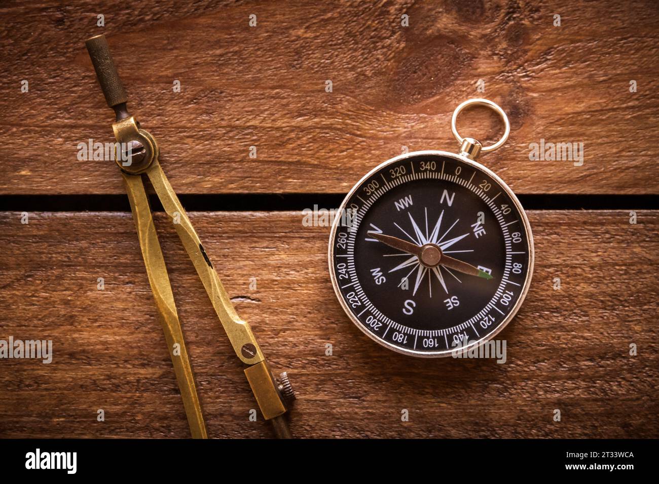 Vintage drawing and navigational Compass on a rustic wooden board Stock ...