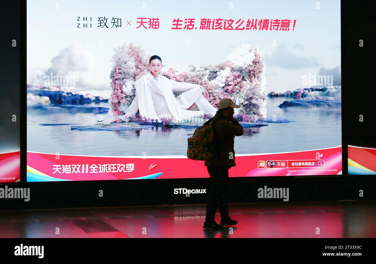 (FILE) Citizens pass posters of Tmall Taobao Double 11 shopping carnival on a subway in Shanghai ...
