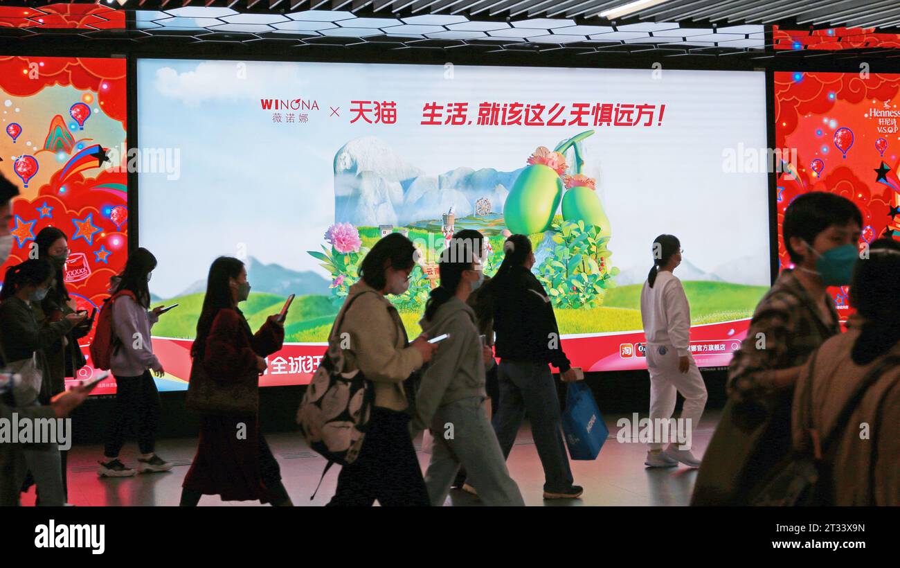 (FILE) Citizens pass posters of Tmall Taobao Double 11 shopping carnival on a subway in Shanghai ...