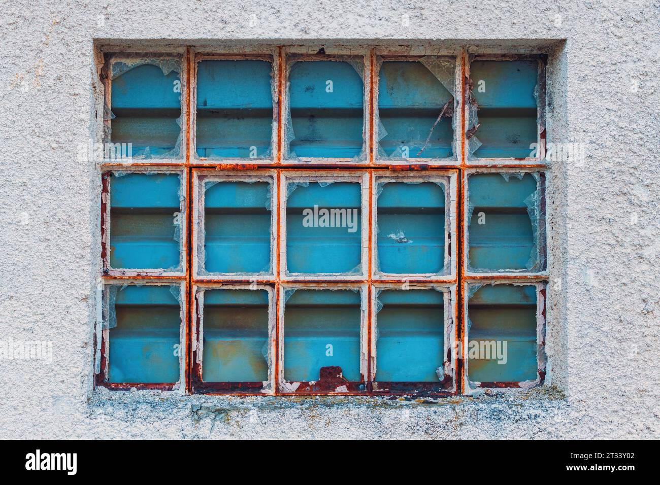 Old factory warehouse grid windows with broken glass as industrial ...