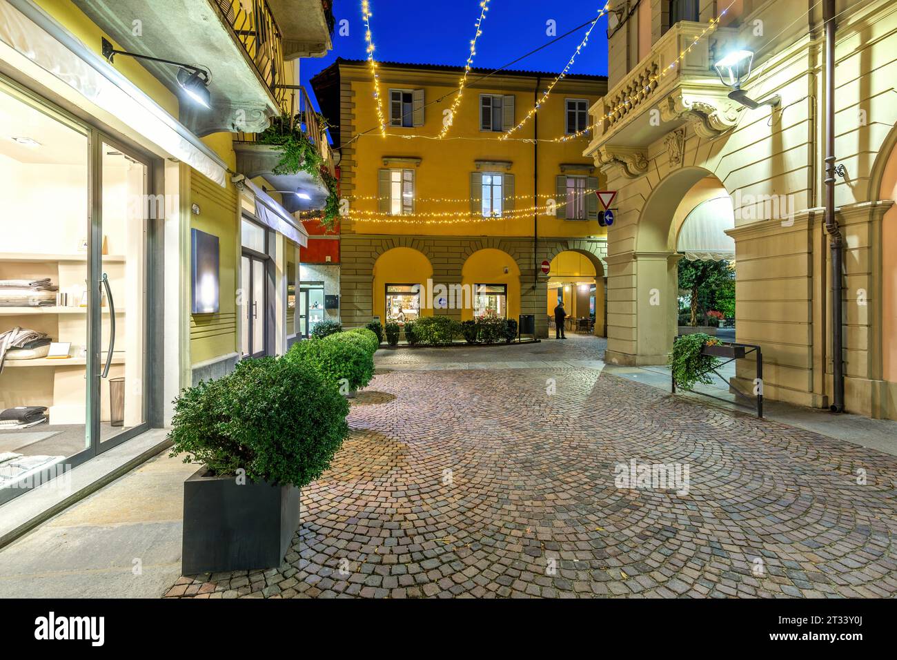 Small cobblestone street among buildings in historic center of Alba ...