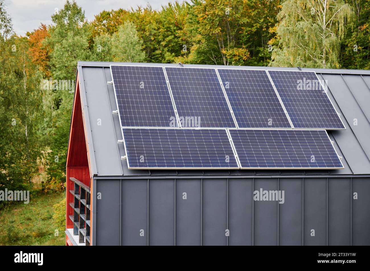 New modern house cottage with solar photovoltaic panel system on roof. Concept of alternative ...