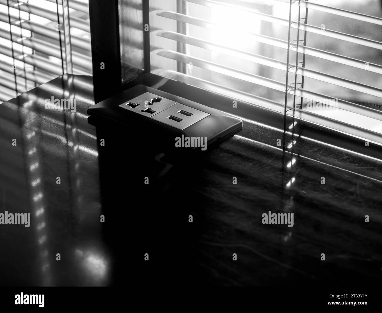 Black dual desk-mounted USB plugs and sockets on dark marble table near ...