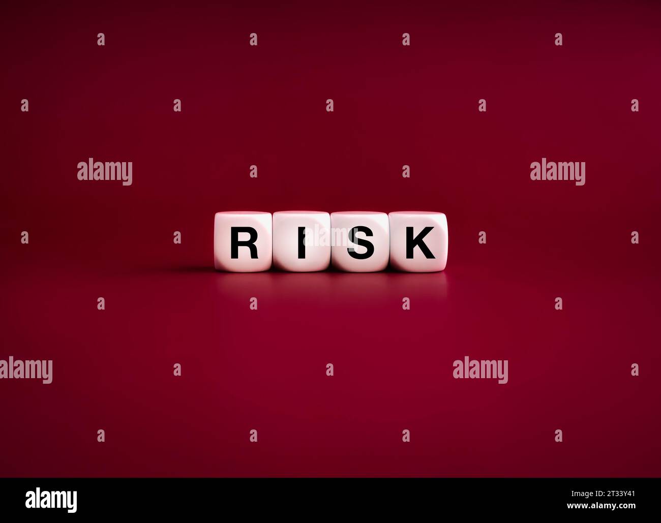 Word "RISK" on white cube blocks isolated on dark red background ...