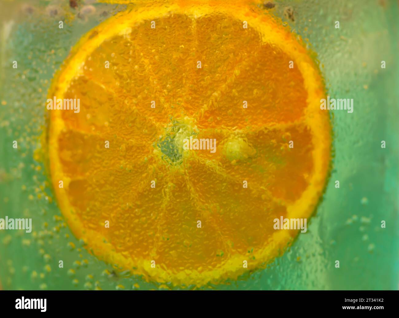 A sliced fresh lemon in the water, shallow focus. Abstract background ...