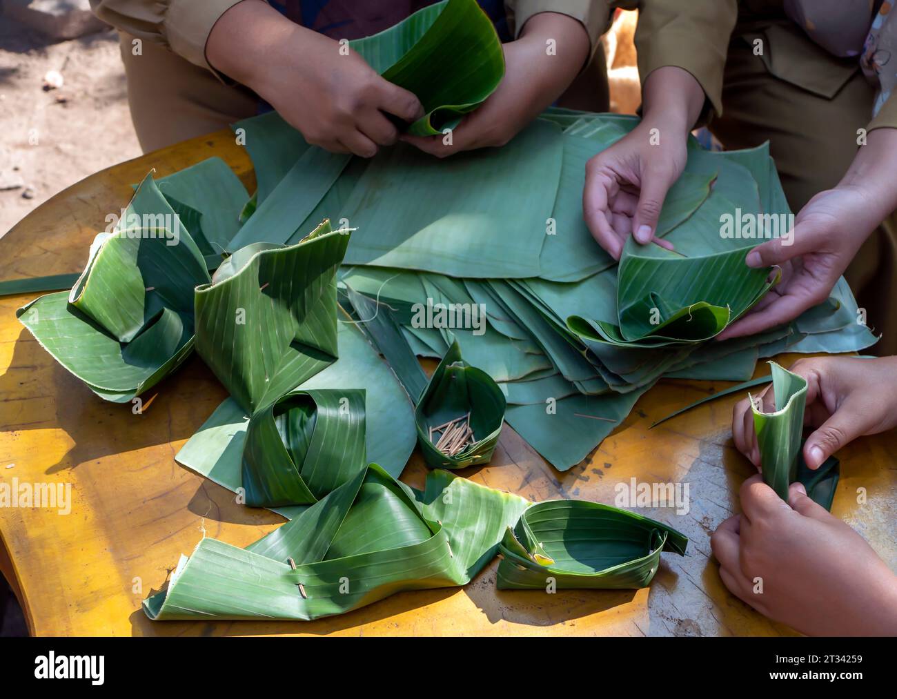The process of making containers made from banana leaves, an ...