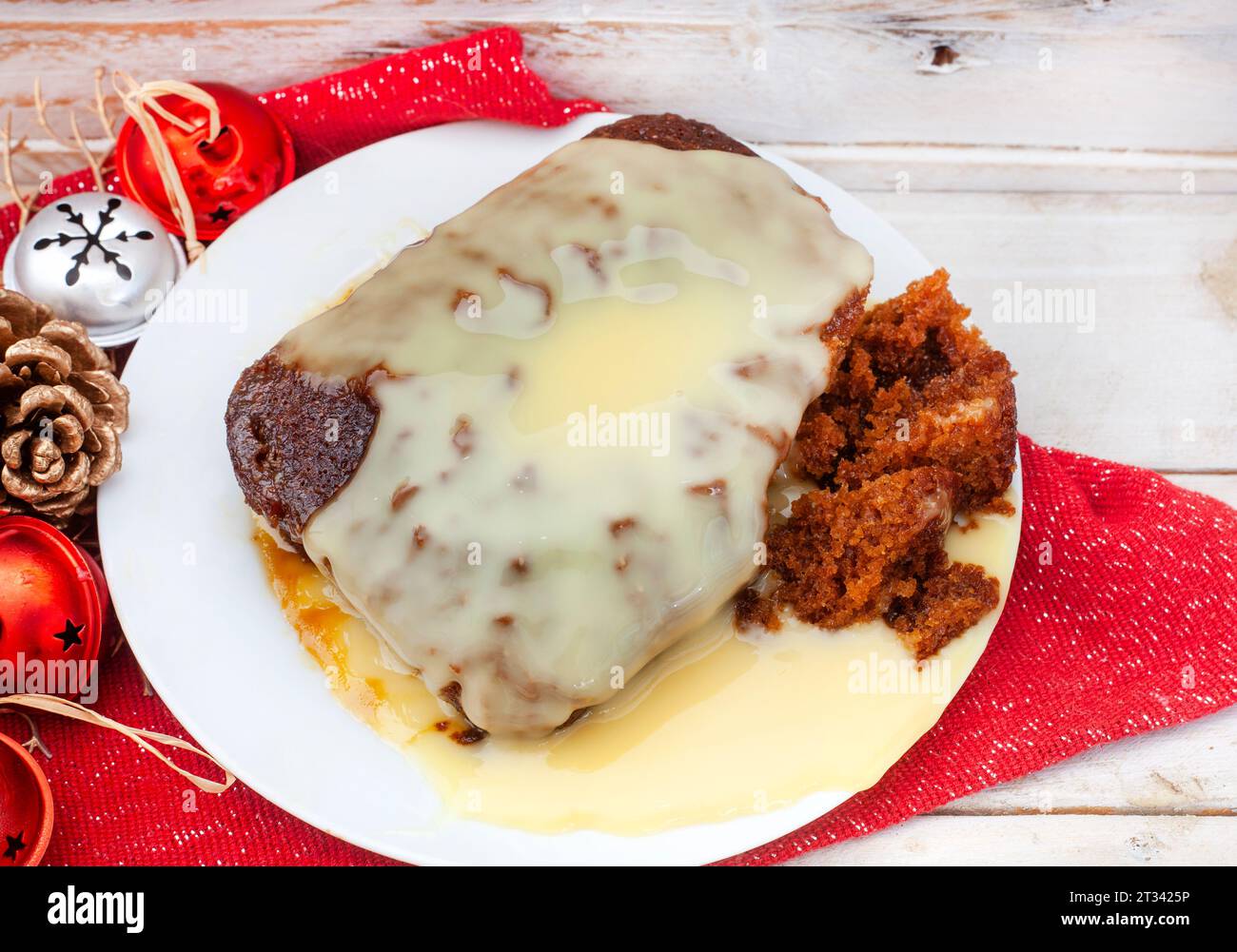 Traditional South African Malva pudding with creamy custard on rustic ...