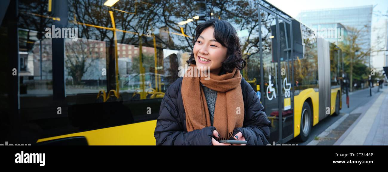 Portrait of korean girl buying ticket for public transport online ...