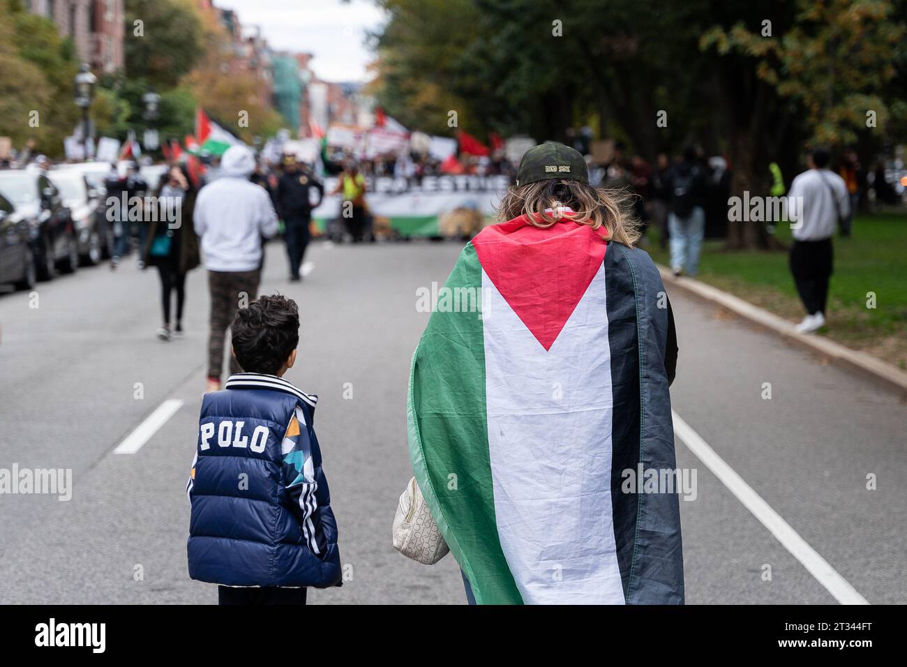 A woman and her son walk in front of the main Pro-Palestine march in ...