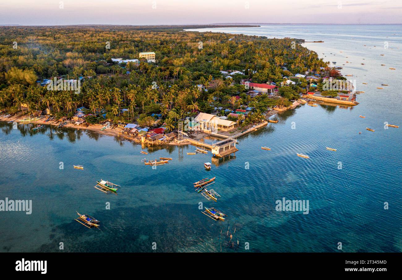 Aerial view of Sulangan with traditional fishing bangka boats at sunset ...