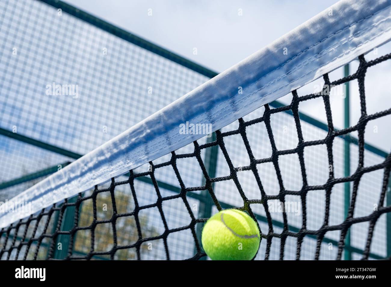 ball hitting the net of a paddle tennis court, racquet sports concept ...