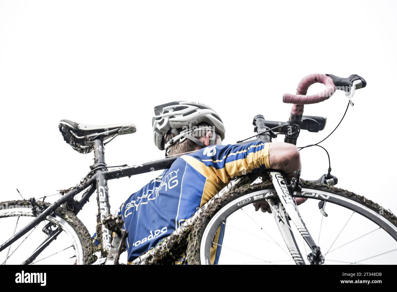Cyclocross rider. Single Cyclocross rider carrying his bike during a ...