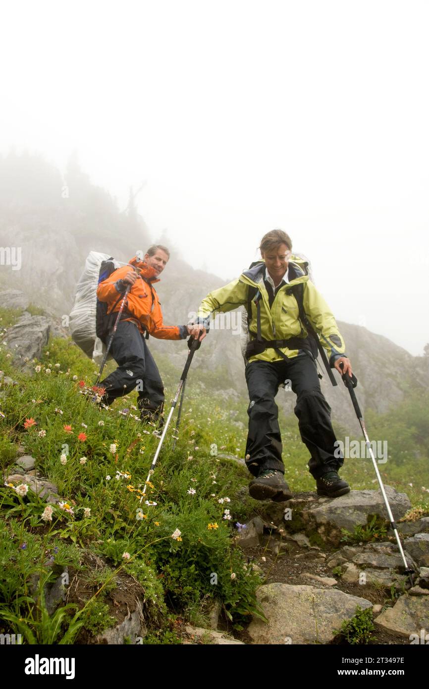 Two hikers making their way day a steep section of trail Stock Photo ...