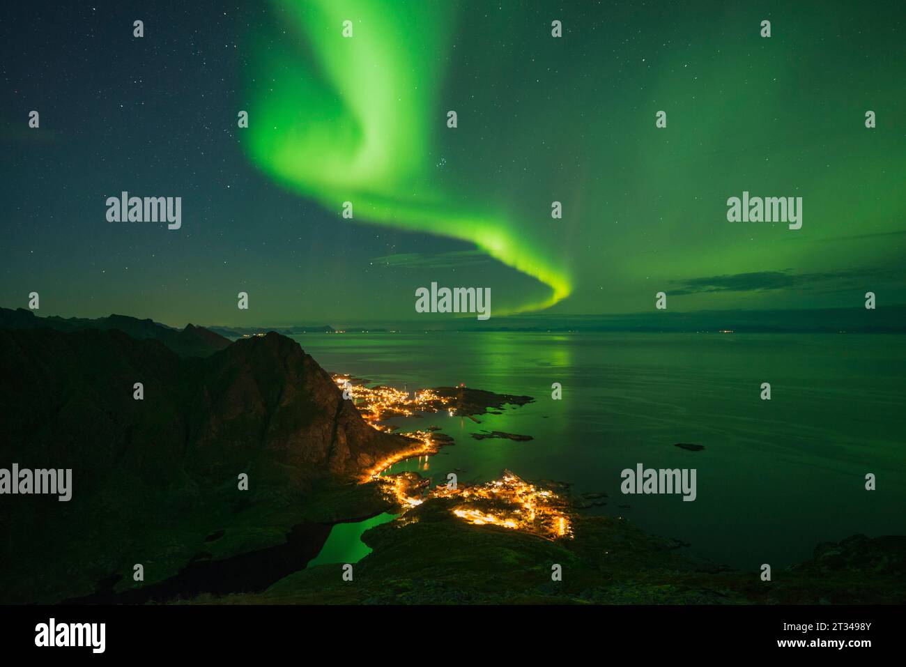 Aurora borealis over coastal village, Moskenesoya, Lofoten, Norway ...
