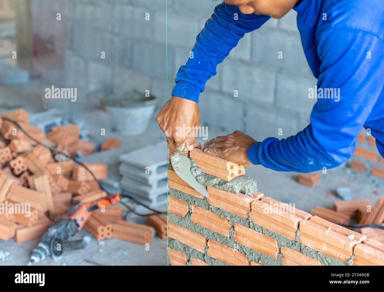 Bricklayer industrial worker installing brick masonry with trowel putty ...