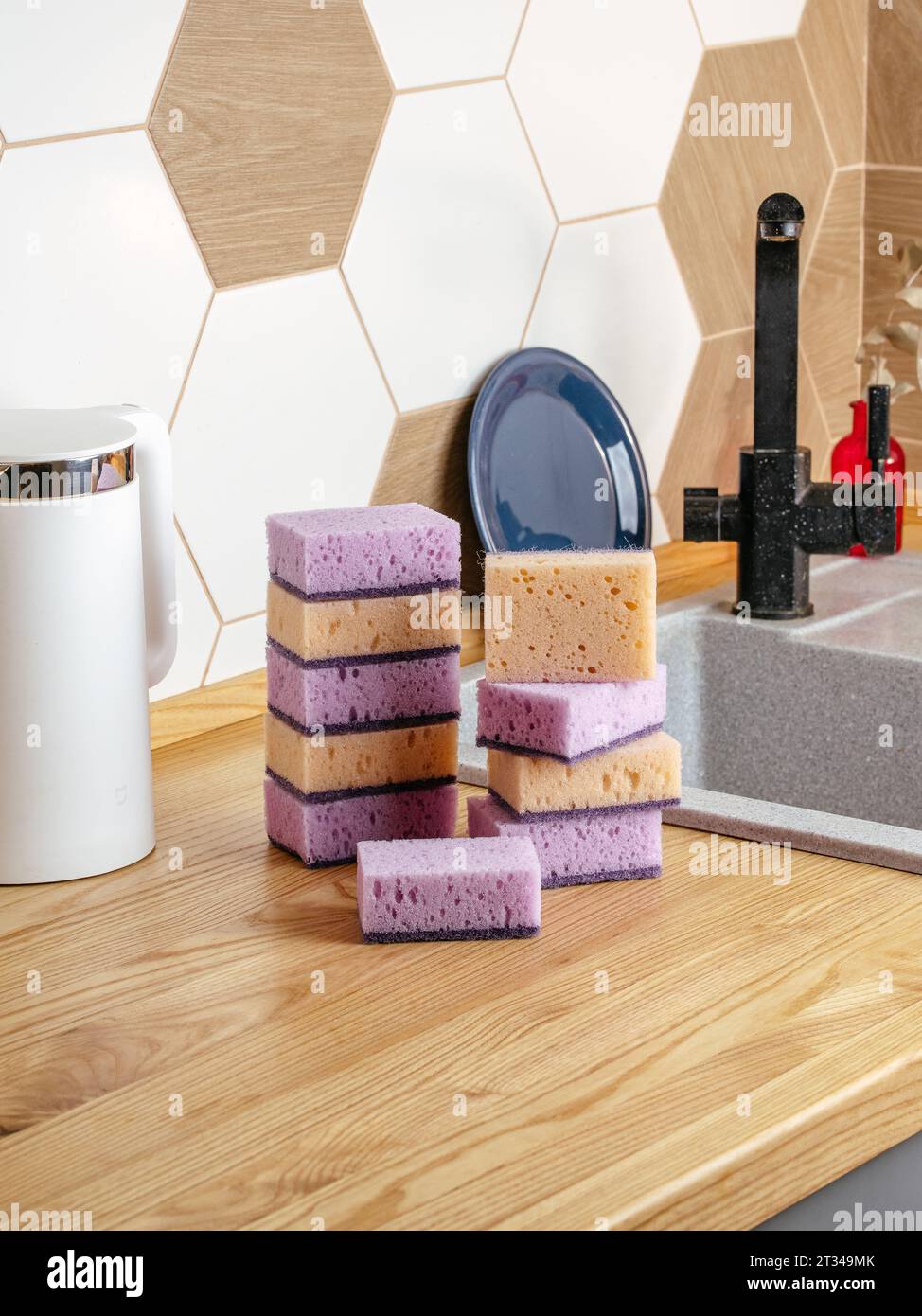 a set of sponges for washing dishes lies on a wooden table Stock Photo ...