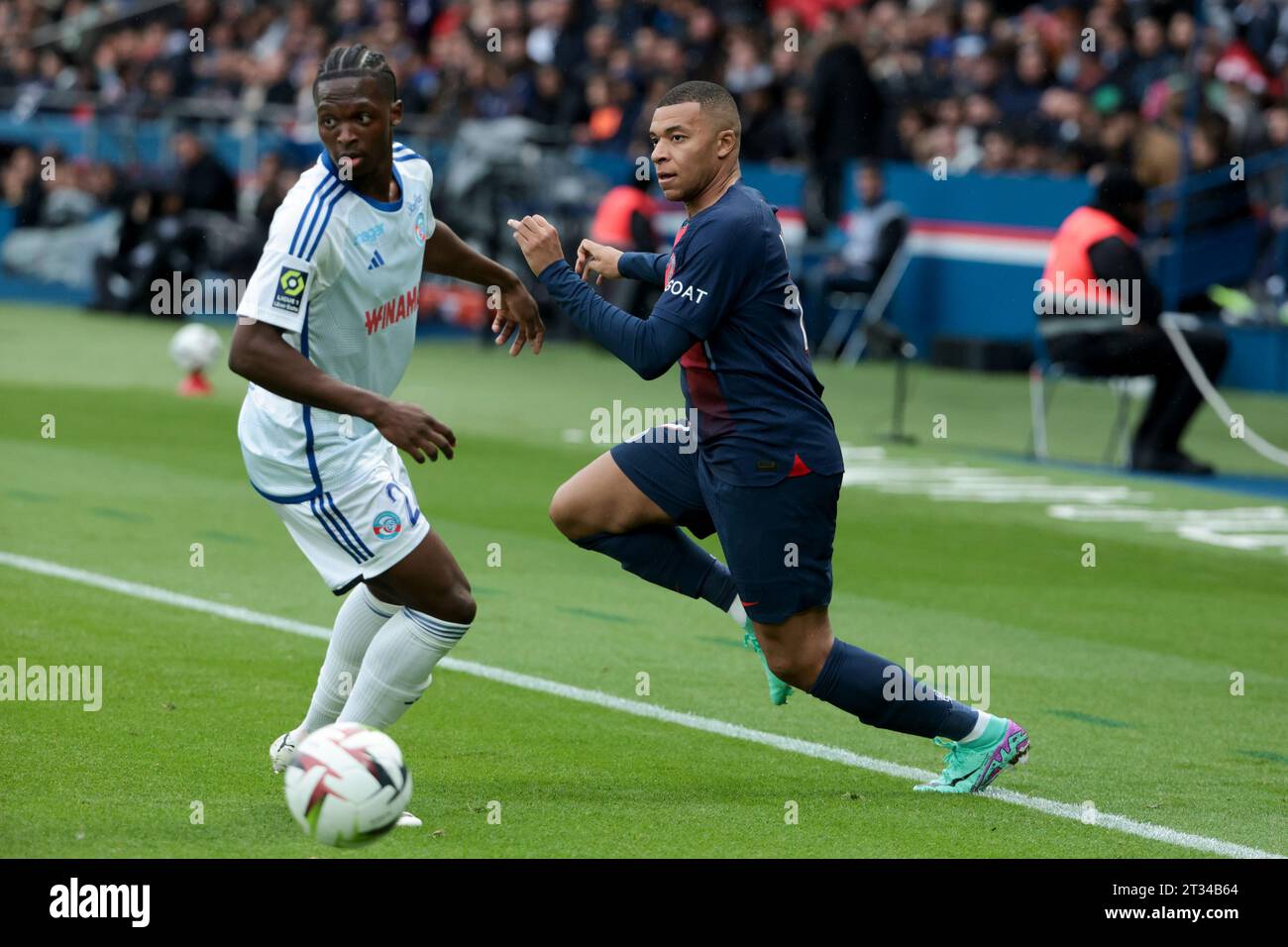 Paris, France. 21st Oct, 2023. Kylian Mbappe of PSG, left Dilane Bakwa of Strasbourg during the ...