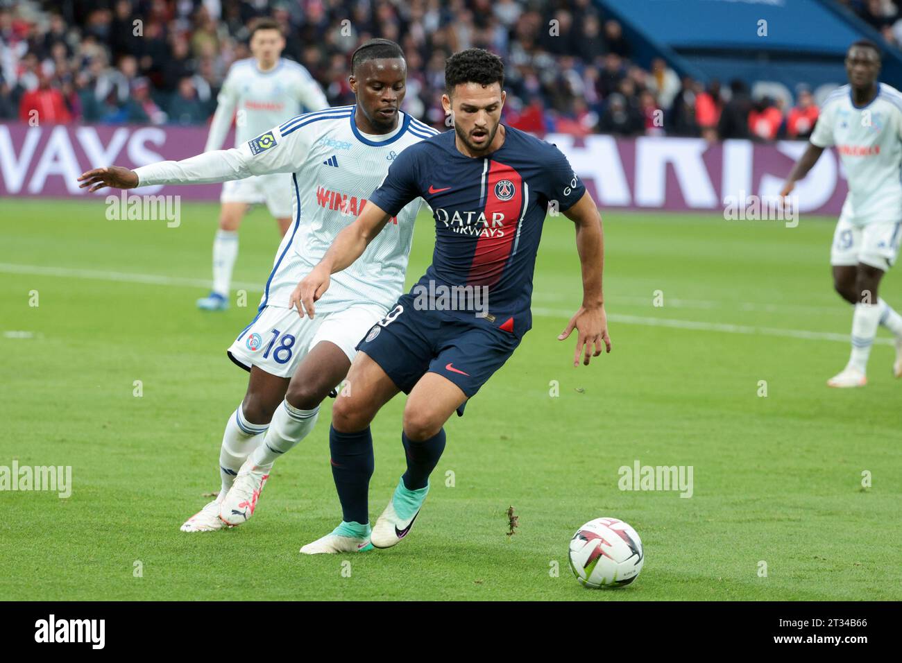 Paris, France. 21st Oct, 2023. Goncalo Ramos of PSG, left Junior Mwanga of Strasbourg during the ...