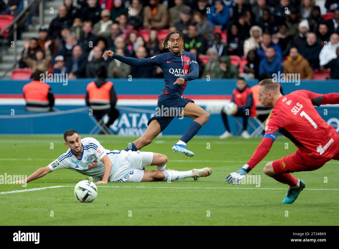 Paris, France. 21st Oct, 2023. Bradley Barcola of PSG, left Lucas Perrin of Strasbourg ...