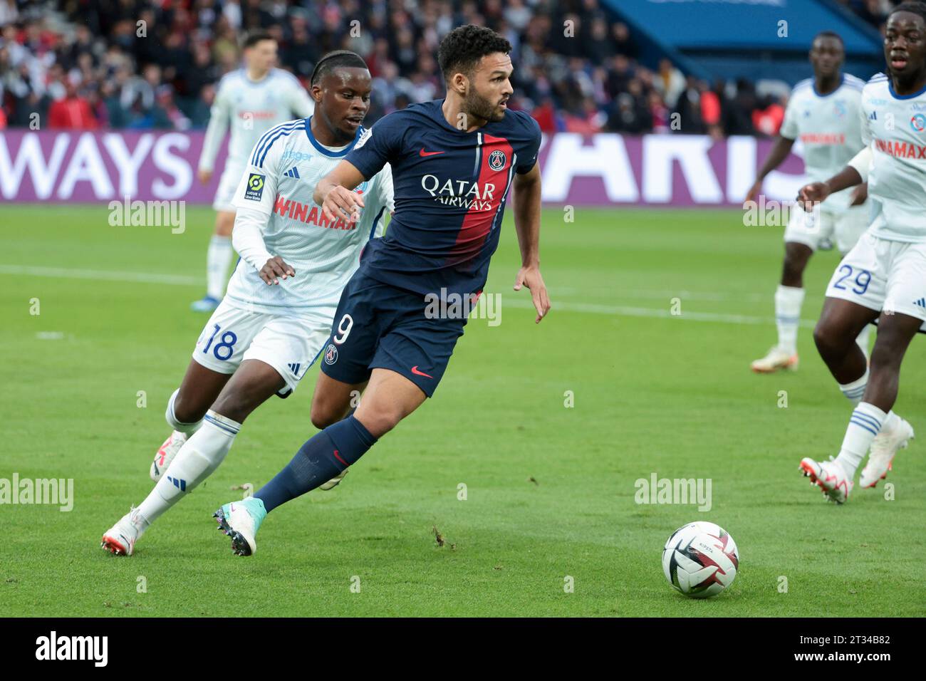 Paris, France. 21st Oct, 2023. Goncalo Ramos of PSG, left Junior Mwanga of Strasbourg during the ...